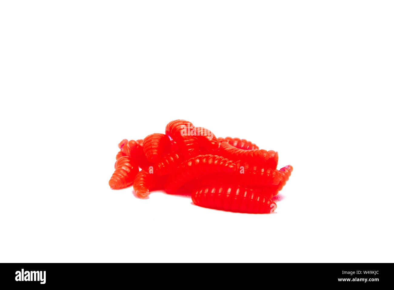 Red Artificial fishing larvae of insects on white background with soft ...