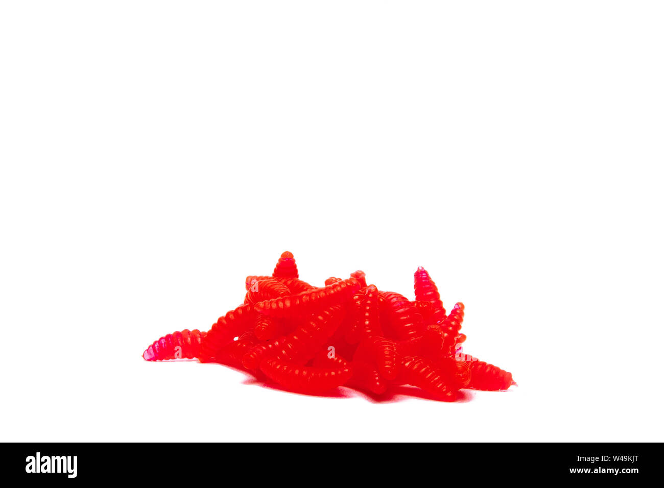 Red Artificial fishing larvae of insects on white background with soft ...