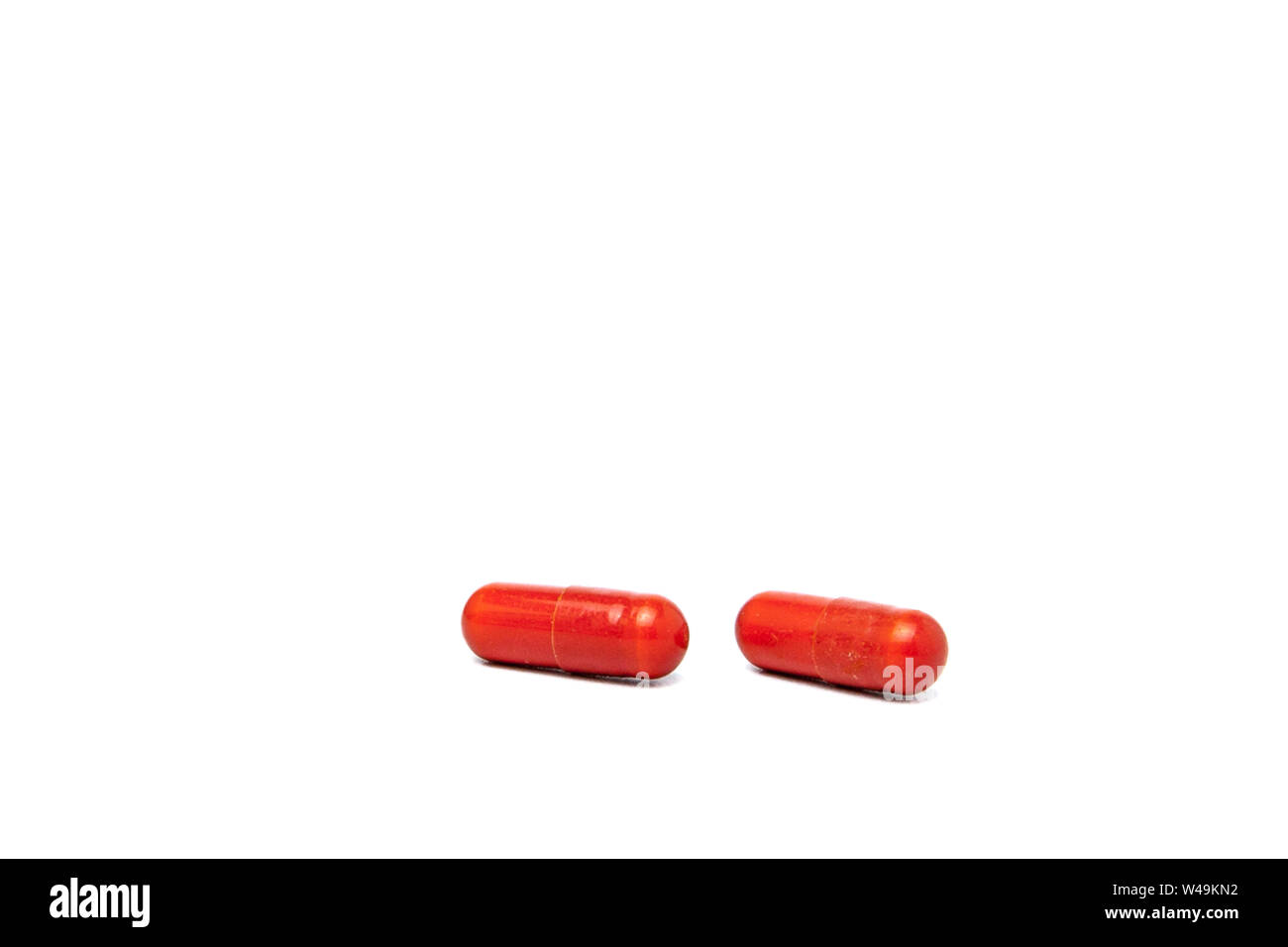 Macro view of brown capsule pill isolated over white background Stock ...