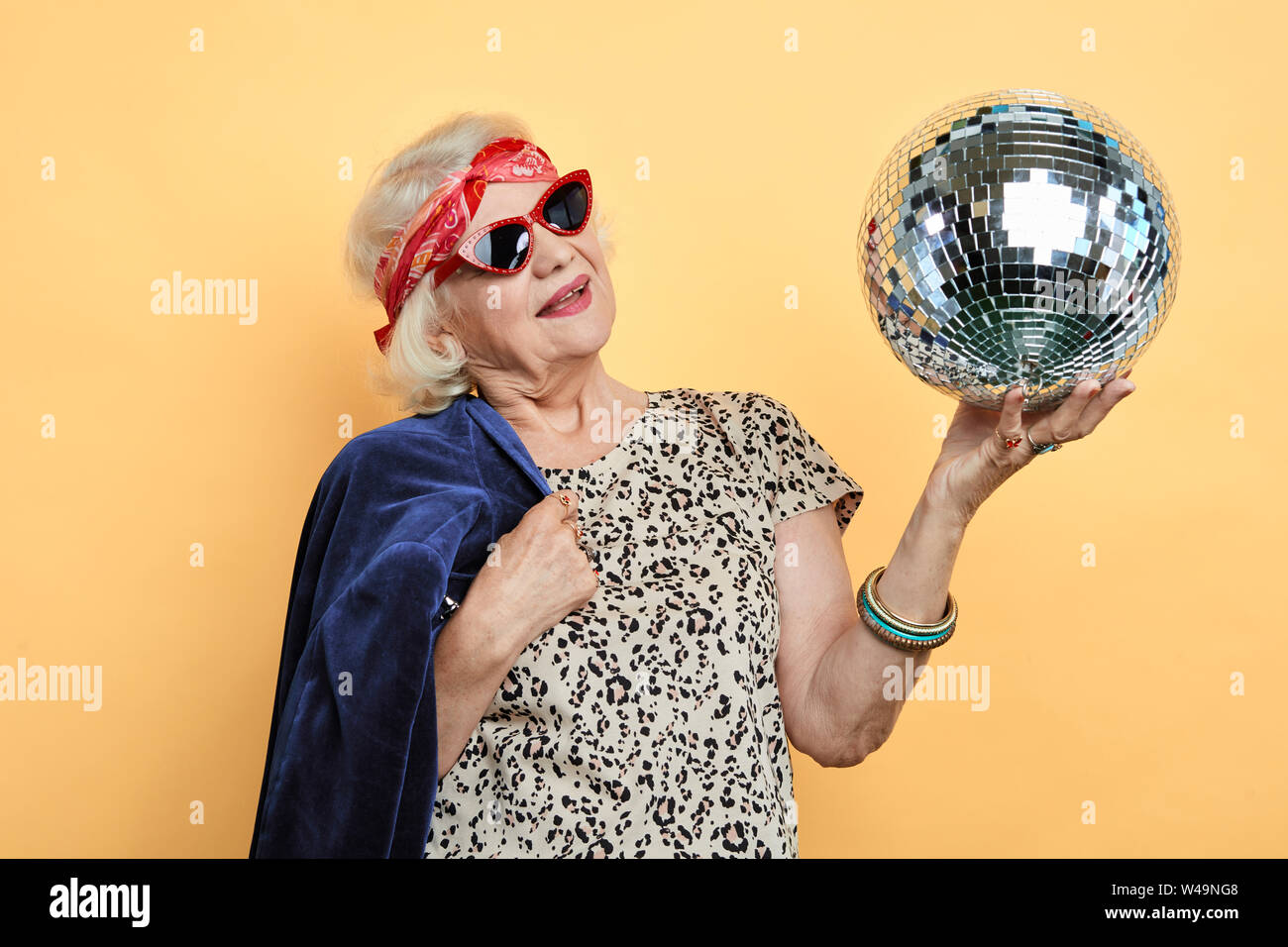 smiling pretty old woman looking at the ball, old lady remember her ...