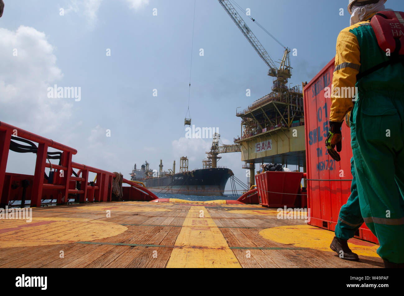 ship crew stand by on deck to received cargo lift to the boat by crane ...