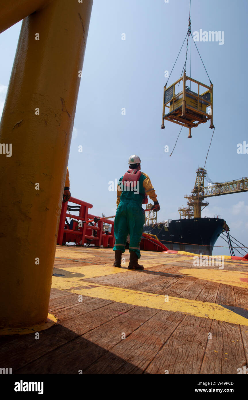 ship crew stand by on deck to received cargo lift to the boat by crane ...