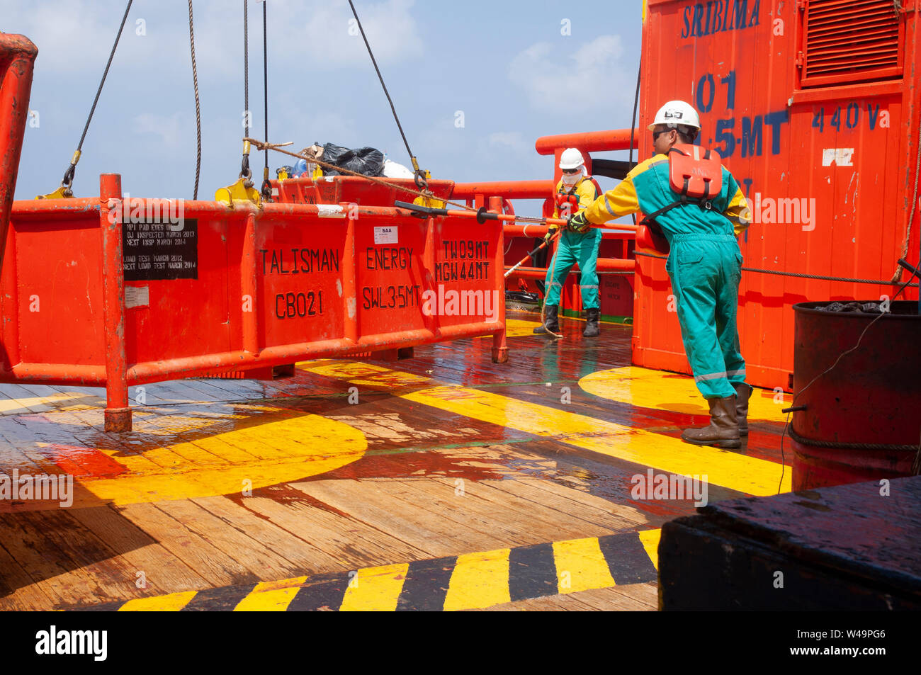 ship crew stand by on deck to received cargo lift to the boat by crane ...