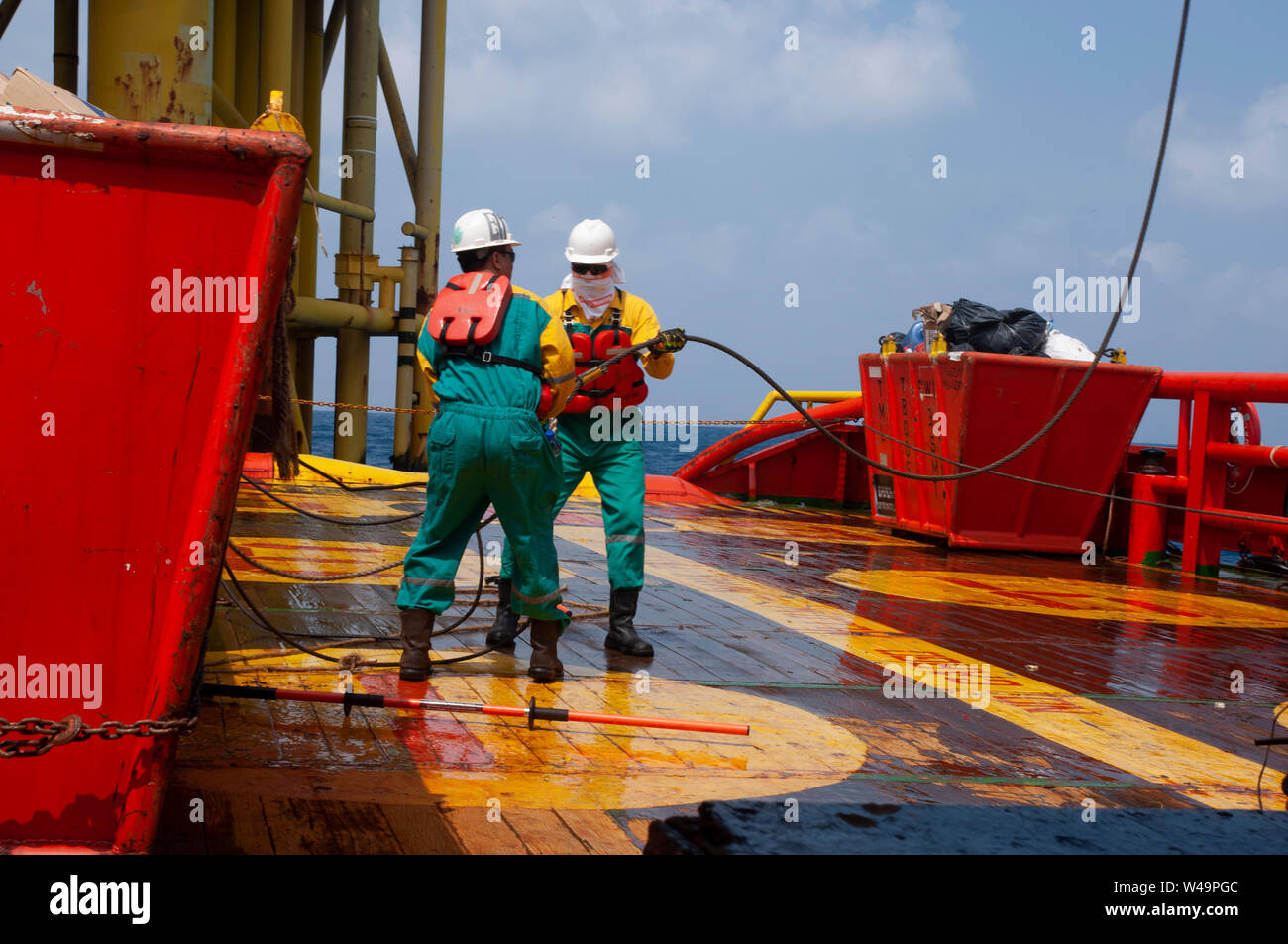 ship crew stand by on deck to received cargo lift to the boat by crane ...