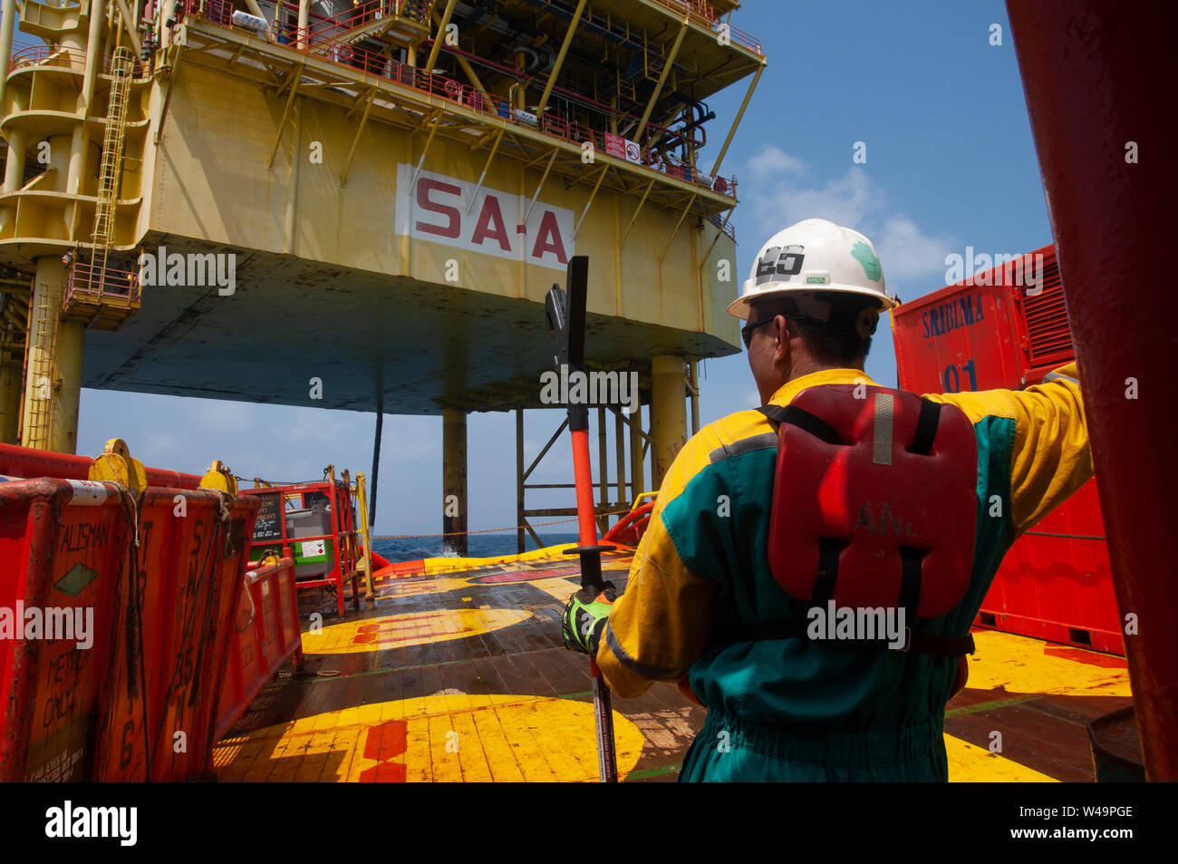 ship crew stand by on deck to received cargo lift to the boat by crane ...