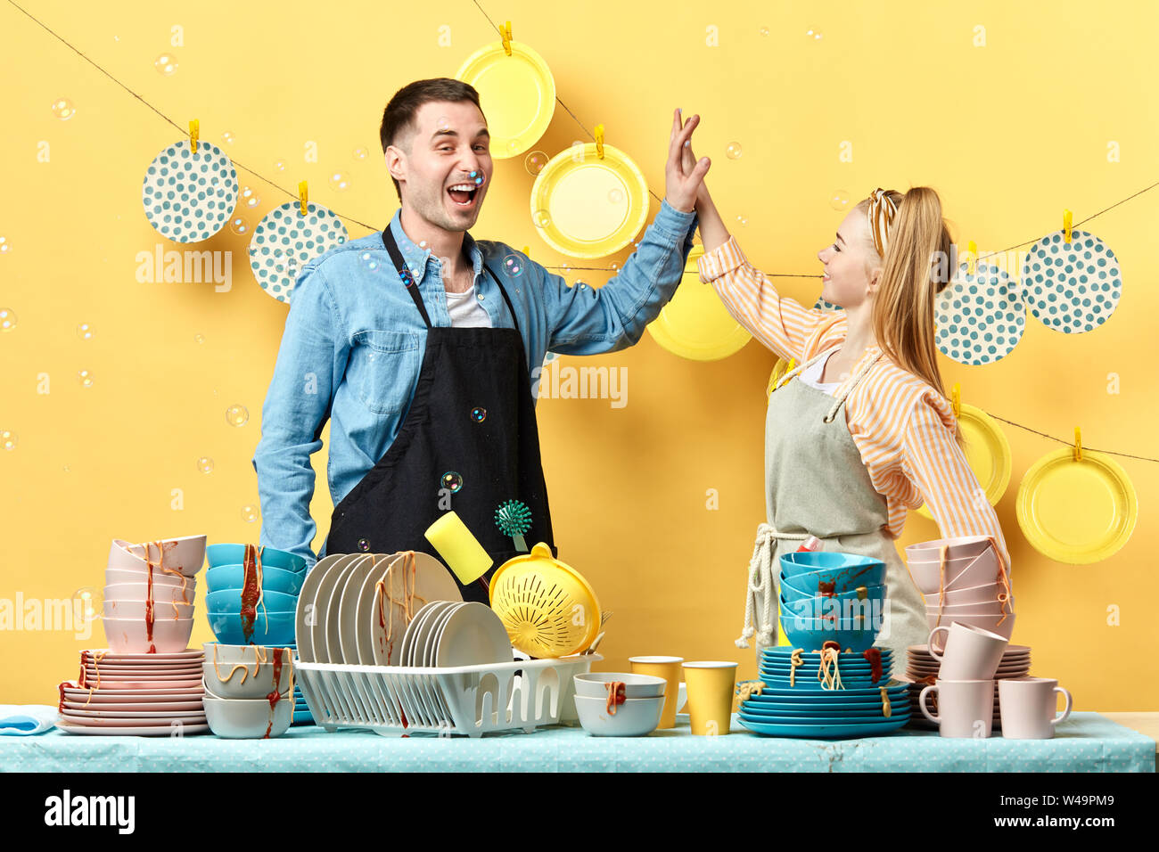 Beautiful active young hardworking couple is giving high five and ...