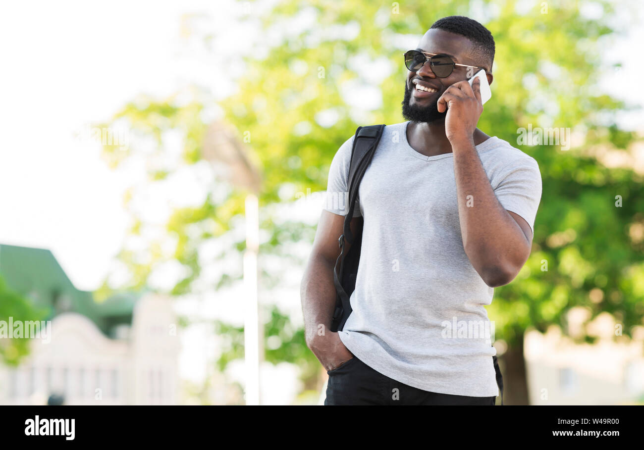 Stylish african man speaking on phone in the city park Stock Photo - Alamy