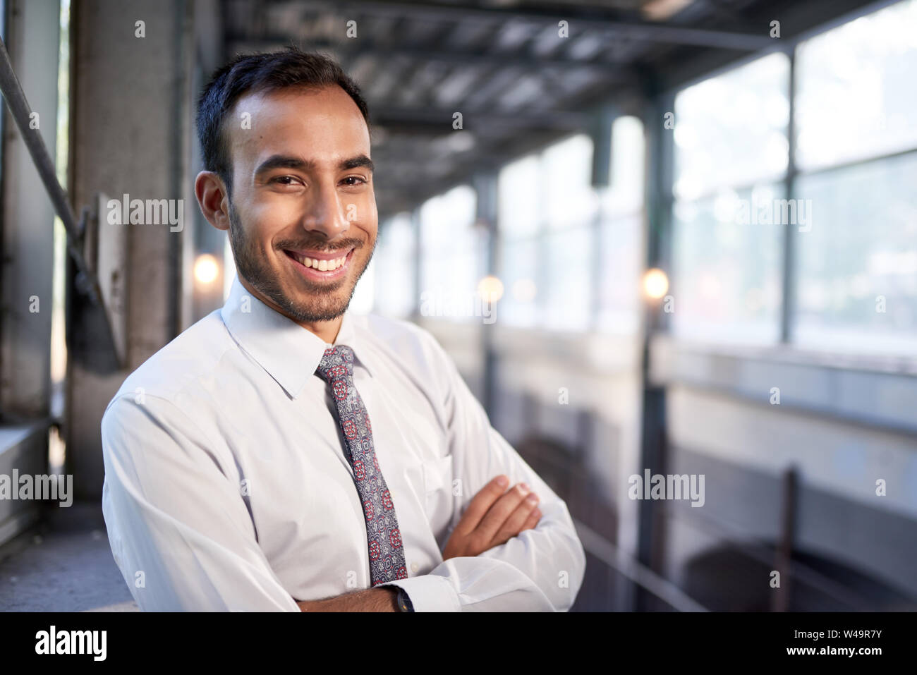 Indian businessman smiling confidently with cityscape background Stock ...