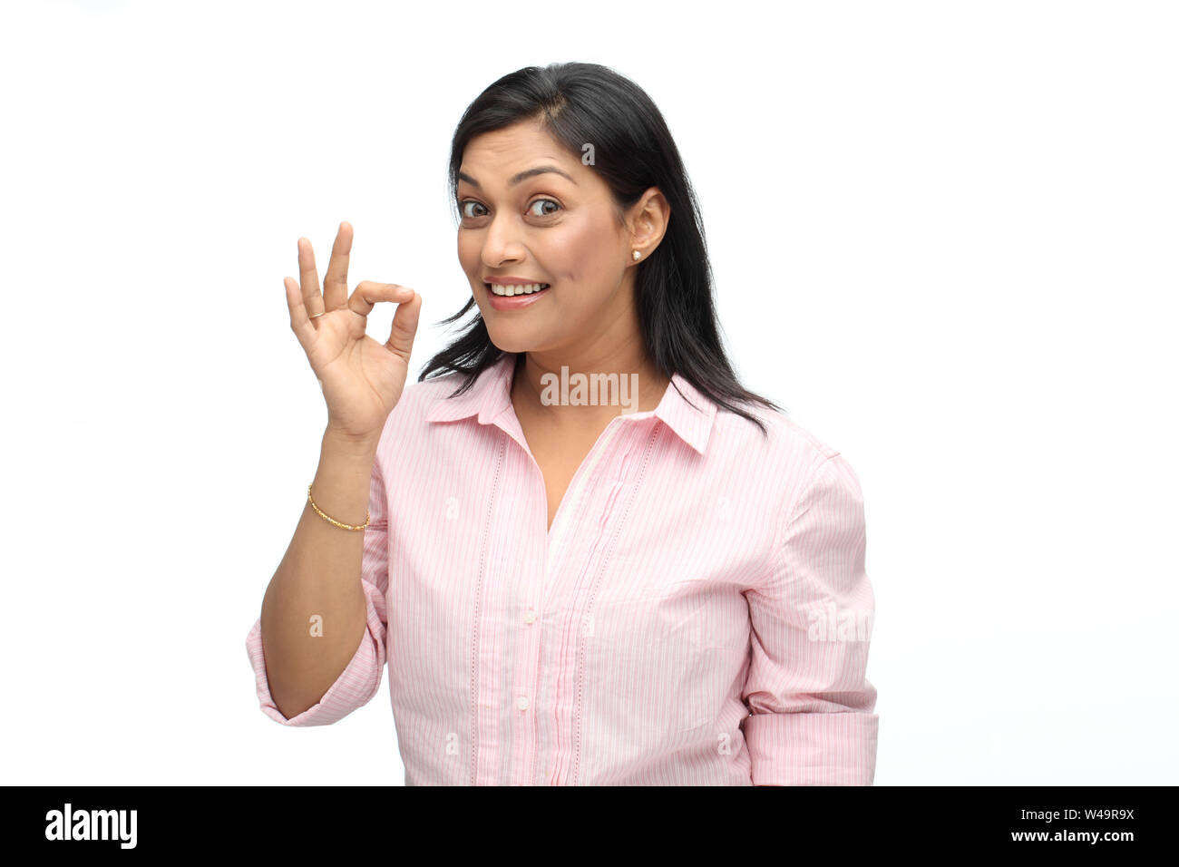 Portrait of a woman showing ok sign Stock Photo - Alamy