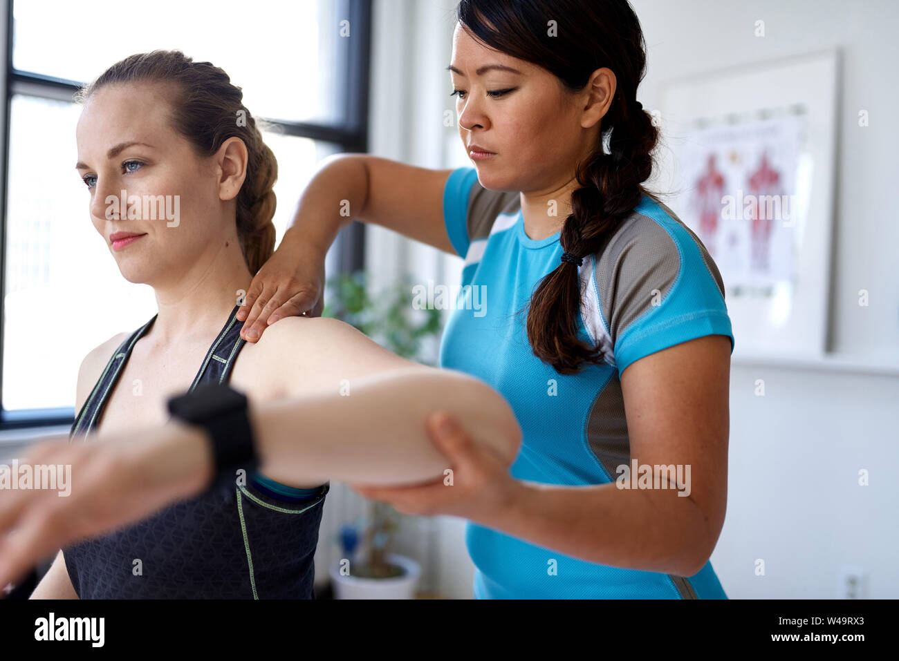 Chinese woman physiotherapy professional giving a treatment to an ...