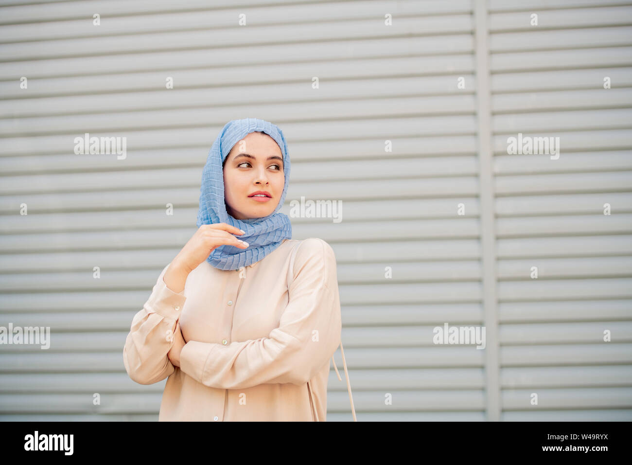 Calm young muslim woman in hijab waiting for taxi or somebody Stock ...