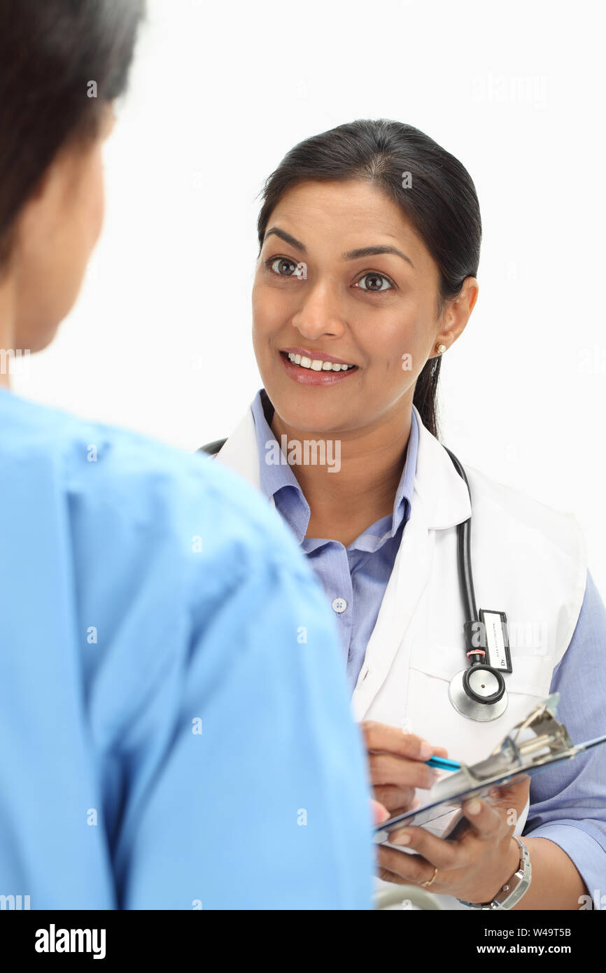 Female doctor consulting with patient Stock Photo - Alamy