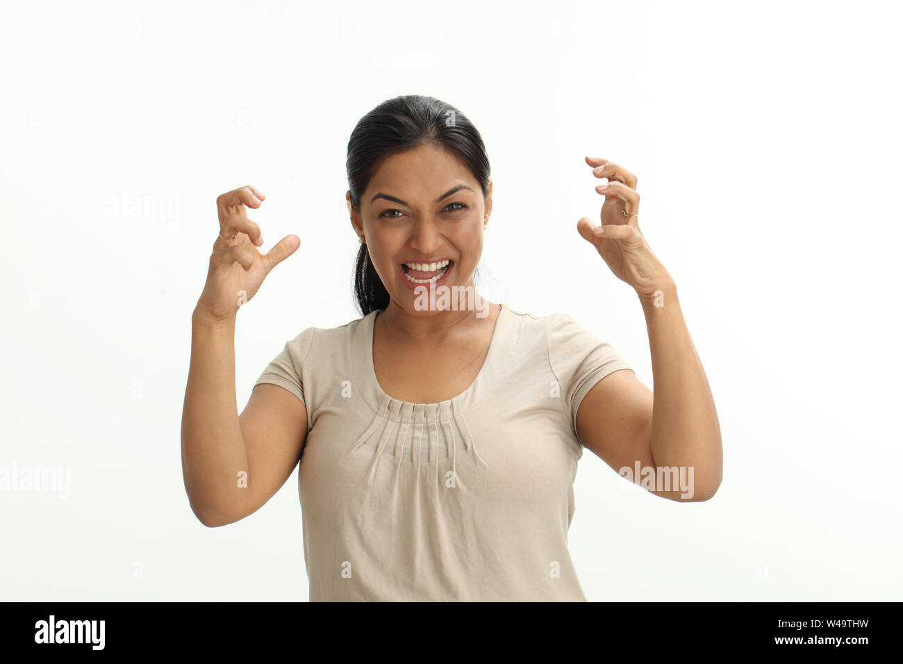 Portrait of a woman laughing with her arms raised Stock Photo - Alamy