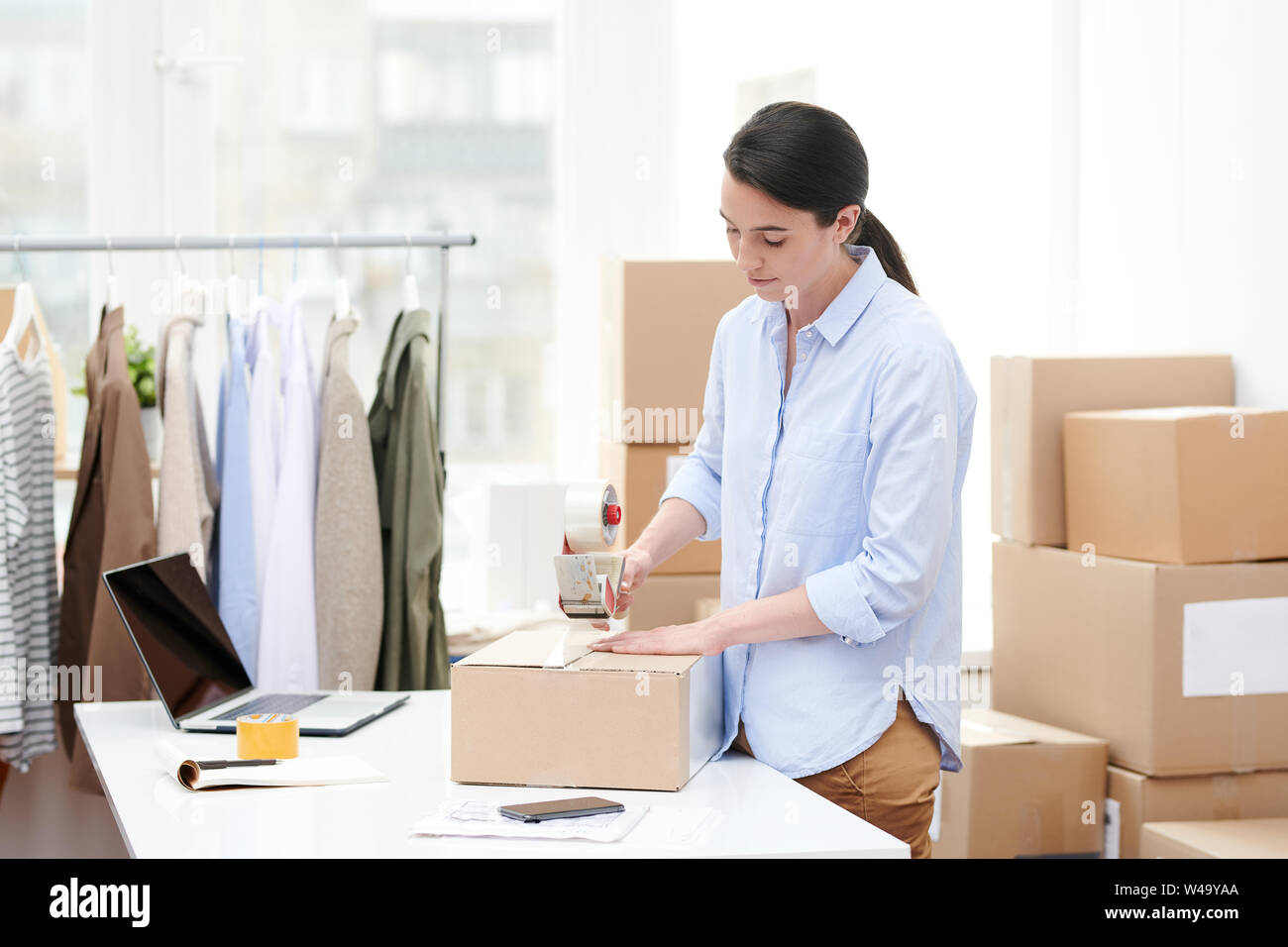 Woman packing box clothes hi-res stock photography and images - Alamy