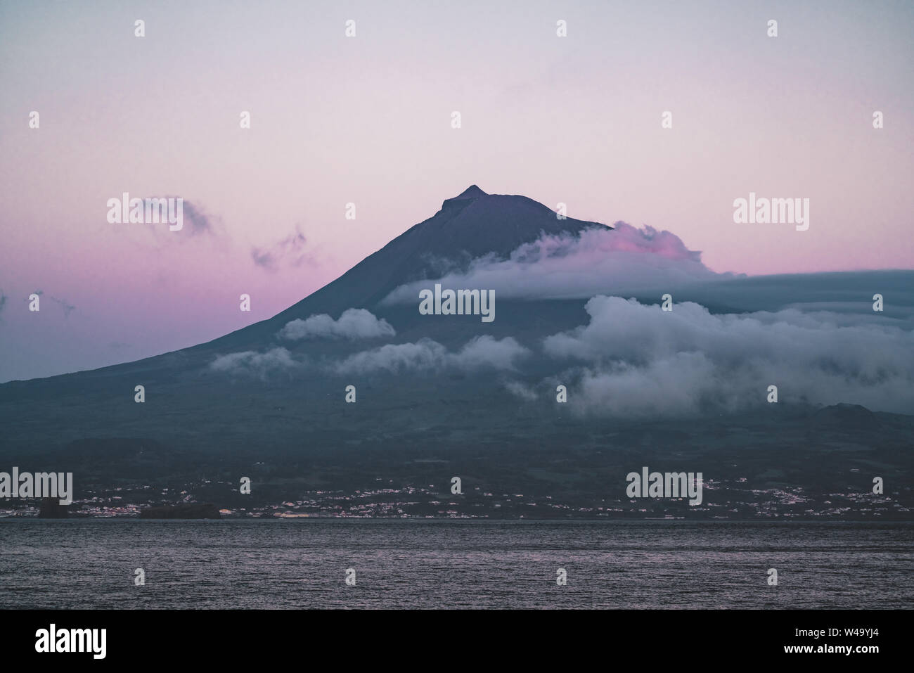 Mount Pico volcano western slope viewed from ocean during full moon ...