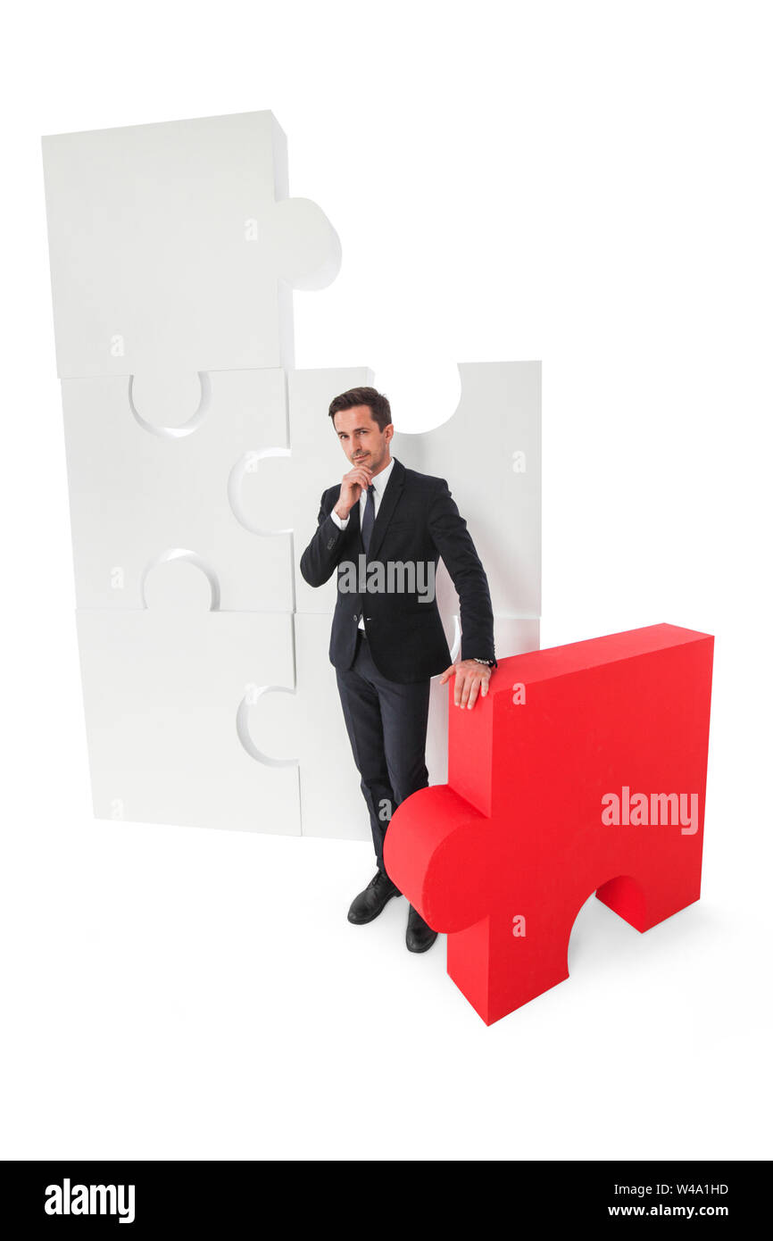 Business man with puzzle pieces thinking about problem solution ...