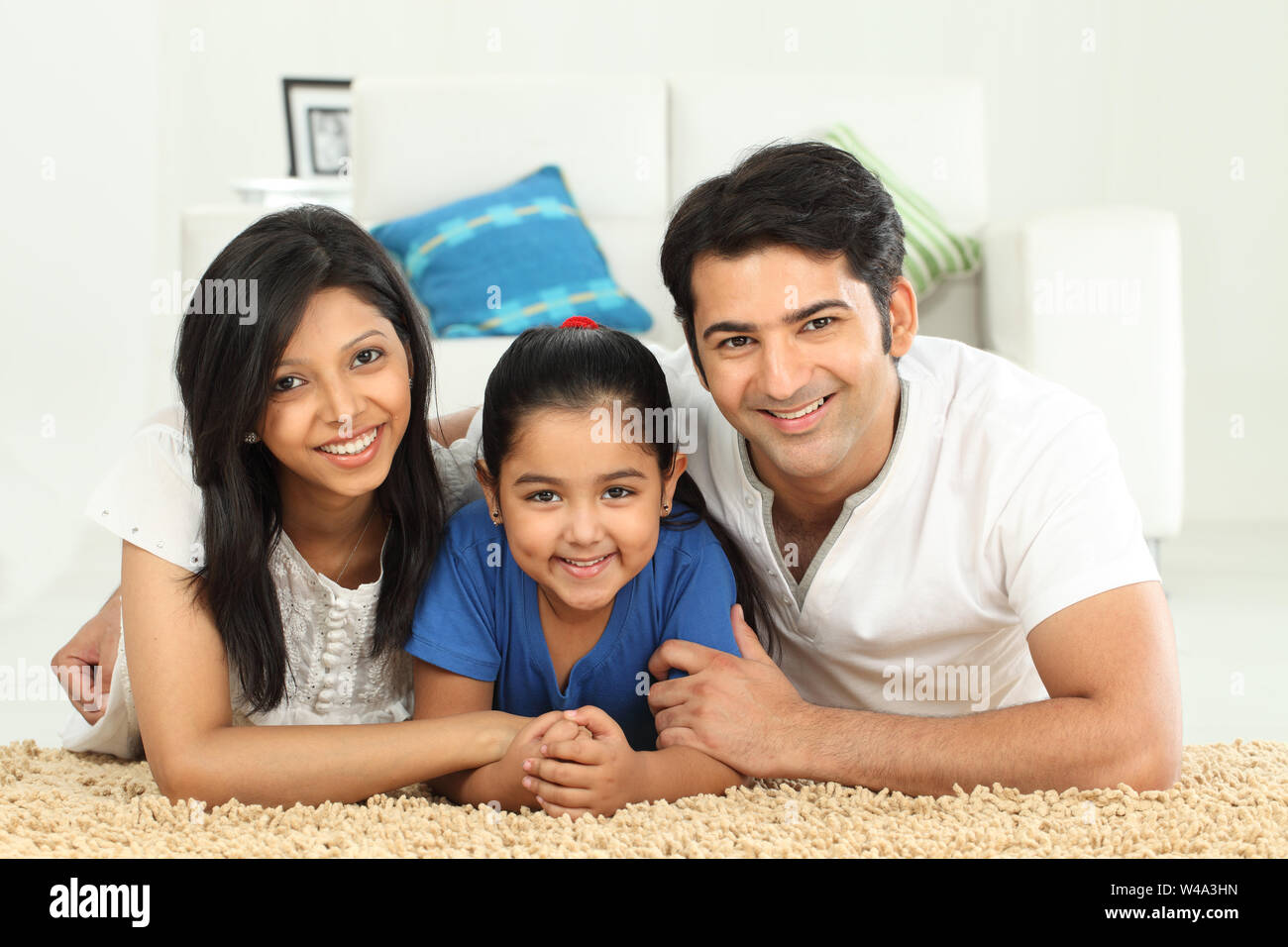 Family smiling at home Stock Photo - Alamy
