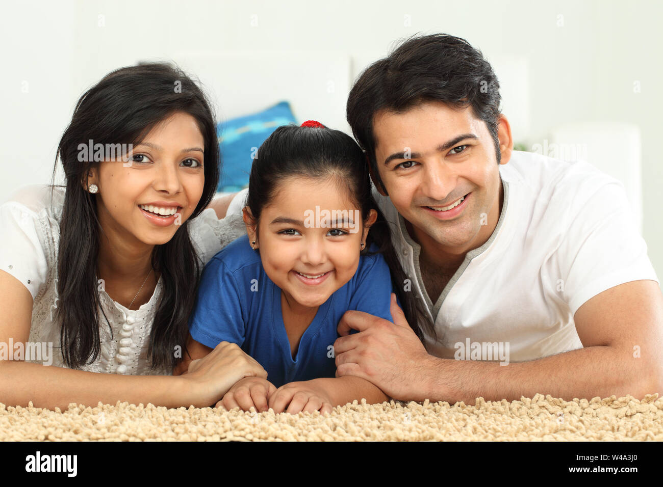 Family smiling at home Stock Photo - Alamy