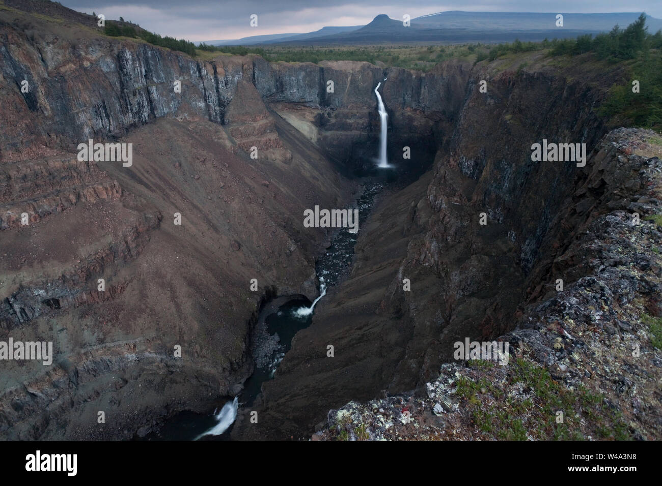 Majestic Waterfall Cascading Into Rugged Canyon Surrounded by Snow ...