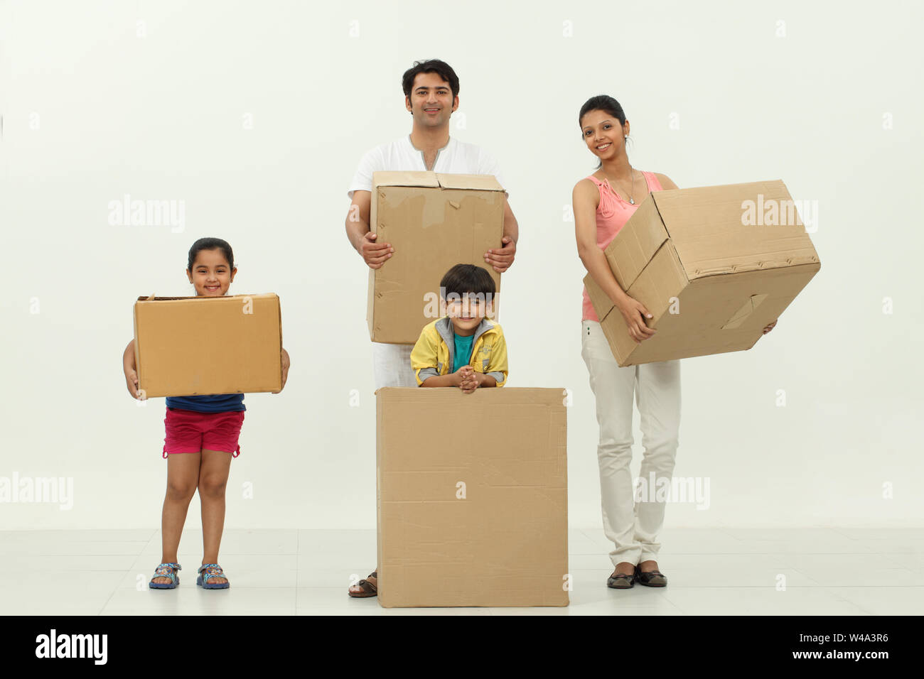 Family moving boxes into New Home Stock Photo - Alamy