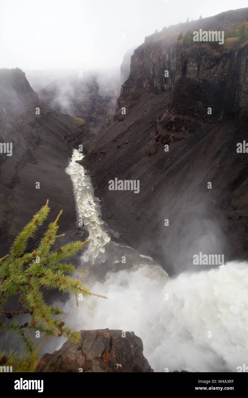 Majestic Waterfall Cascading Into Rugged Canyon Surrounded by Snow ...