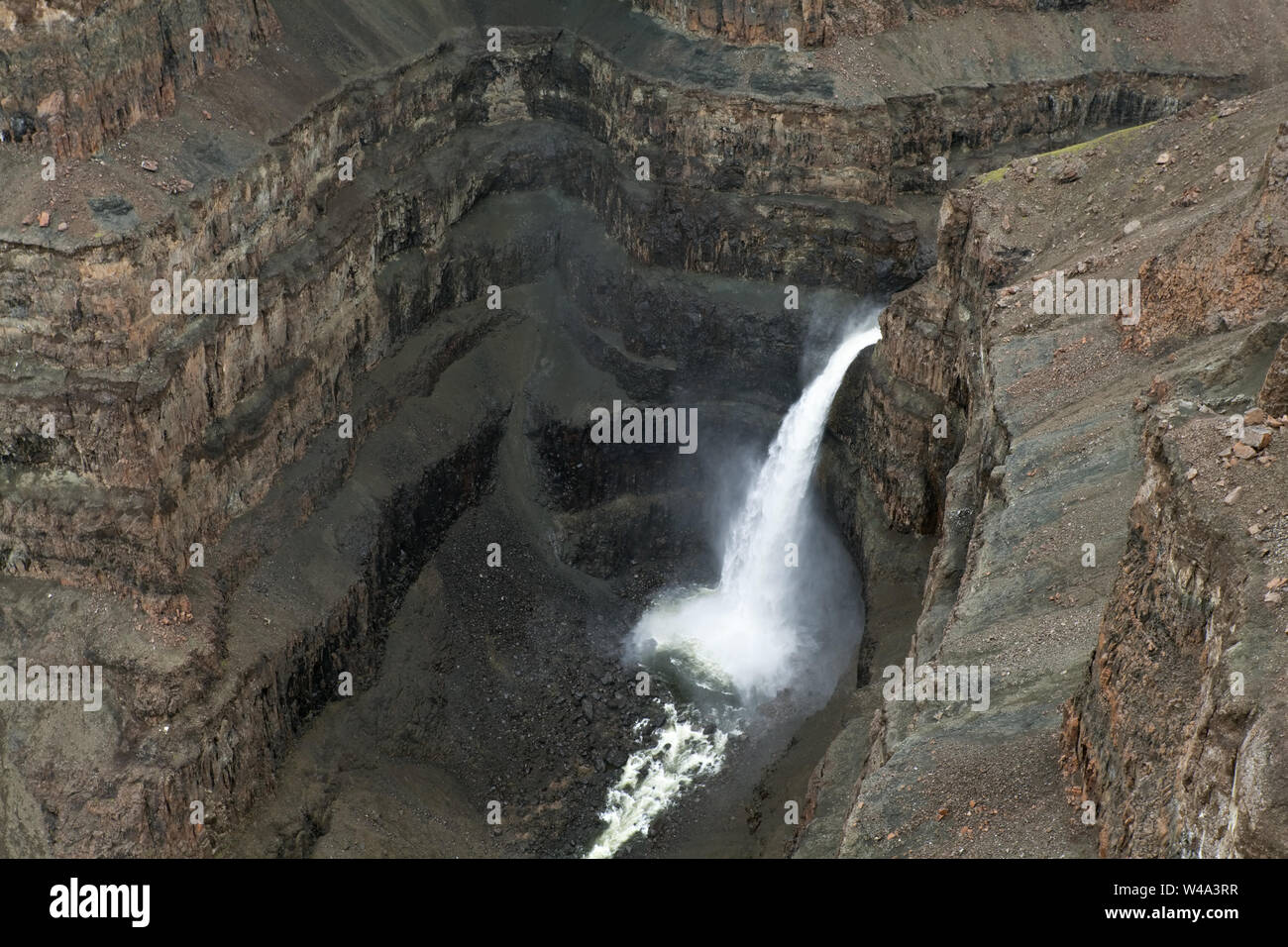 Majestic Waterfall Cascading Into Rugged Canyon Surrounded by Snow ...