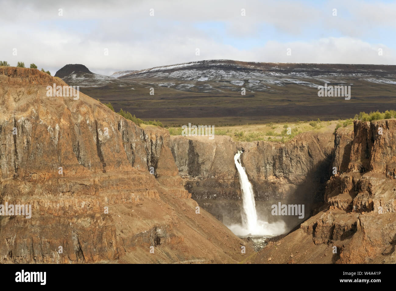 Majestic Waterfall Cascading Into Rugged Canyon Surrounded by Snow ...