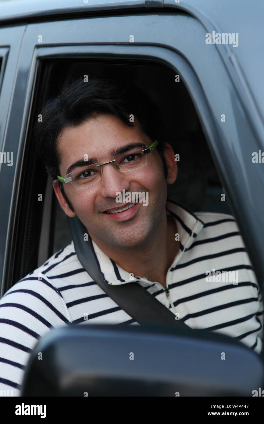 Indian man driving car hi-res stock photography and images - Alamy
