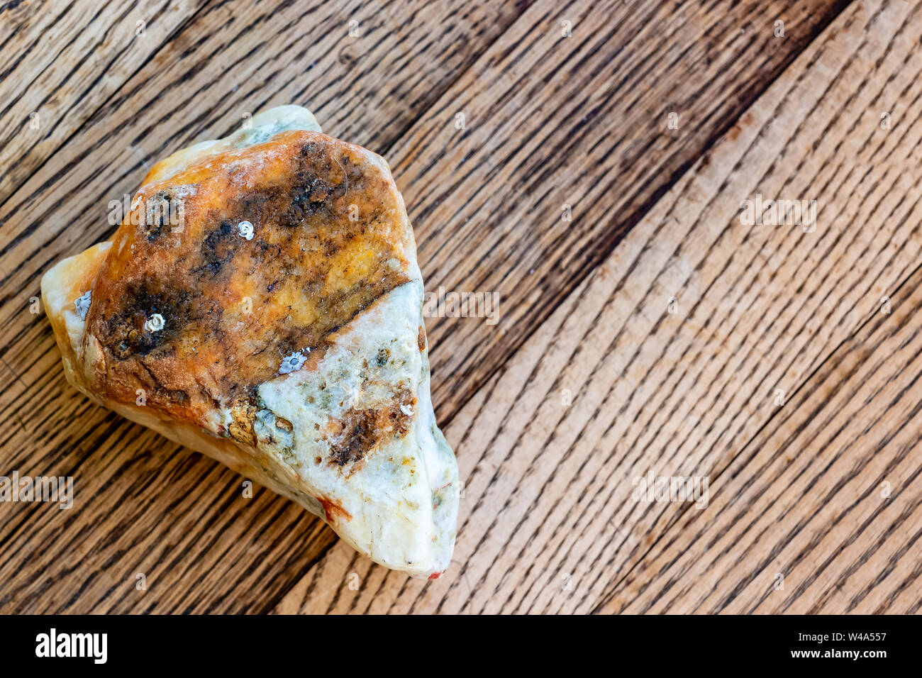 Colorful rainbow stone on rustic wood background Stock Photo - Alamy