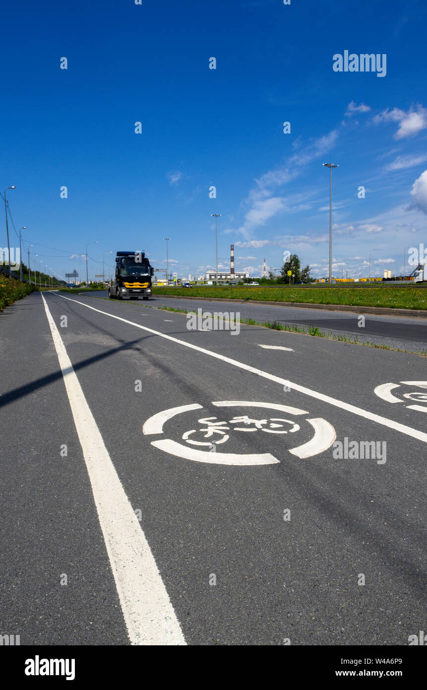 Landscape with road signs "Bicycle path" on the asphalt surface close ...