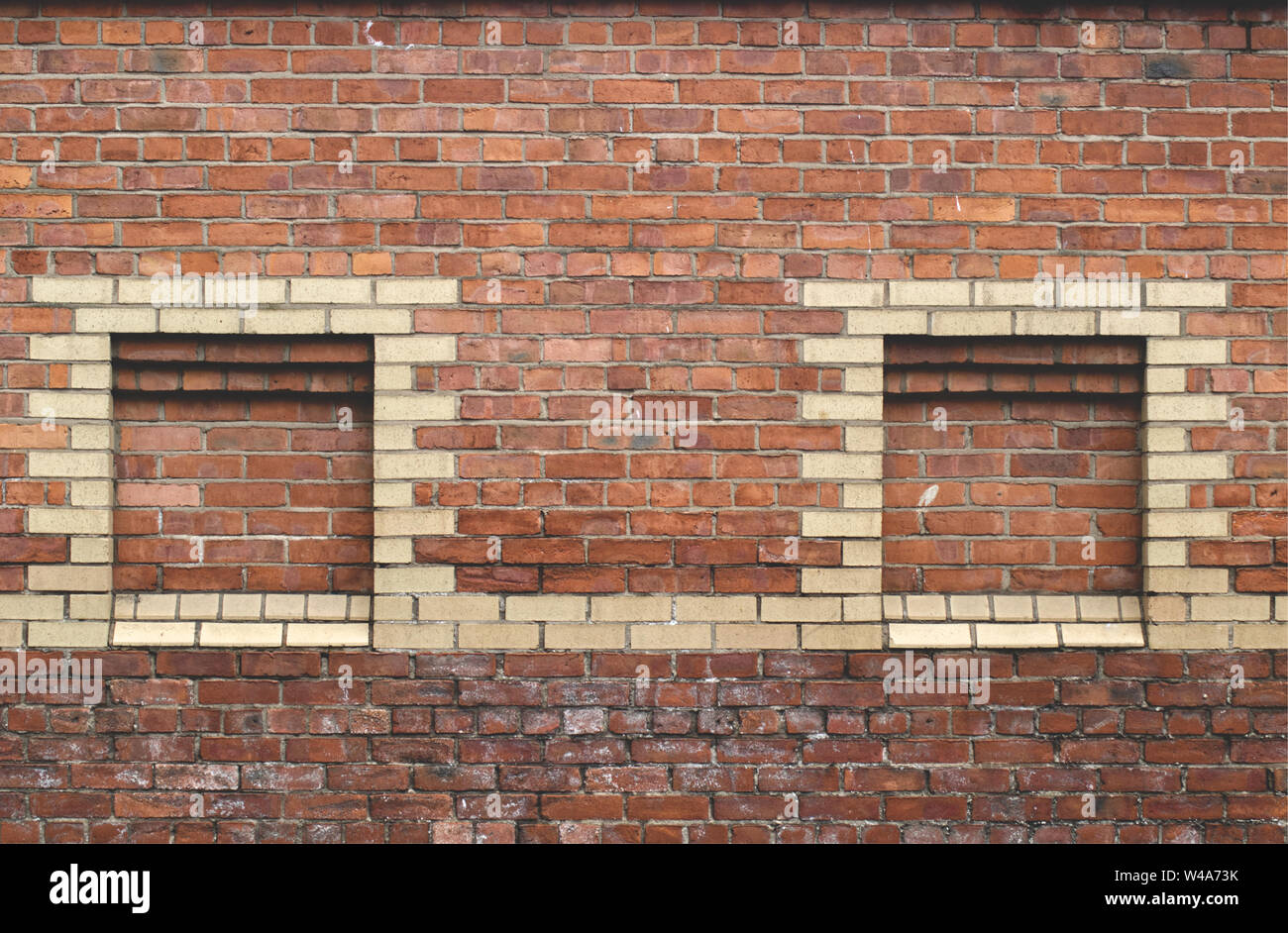 Red brick stone wall with yellow bricks to create tower shapes Stock ...