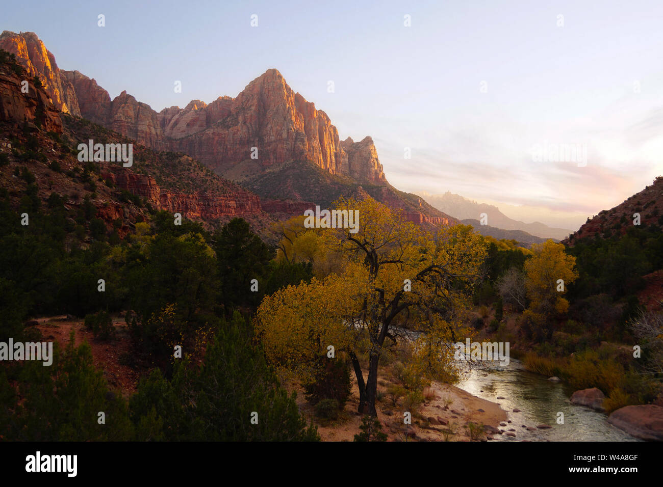 The last rays of light hitting the mountains, river and forests beauty ...
