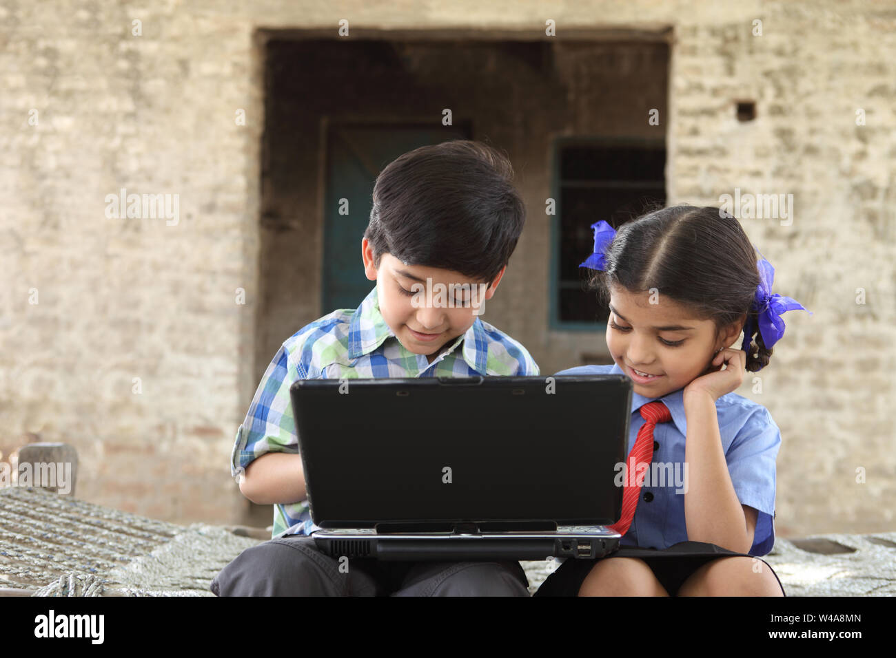 School children using a laptop Stock Photo - Alamy
