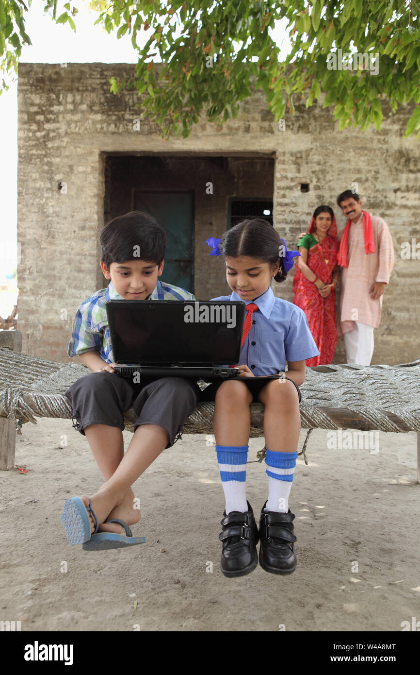 Indian parents children home laptop hi-res stock photography and images ...
