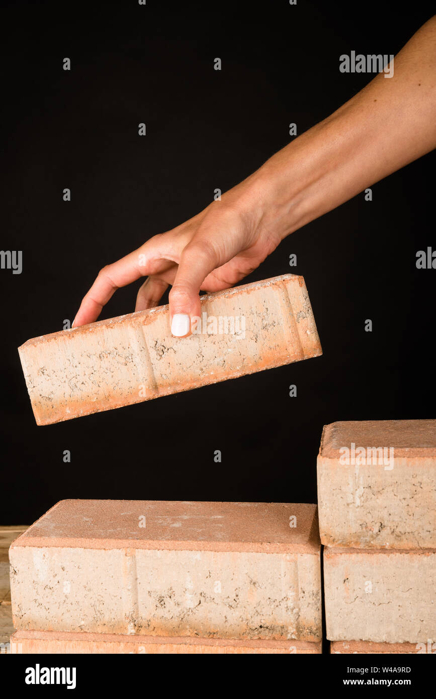 Female hand building a wall, an immigration concept Stock Photo - Alamy
