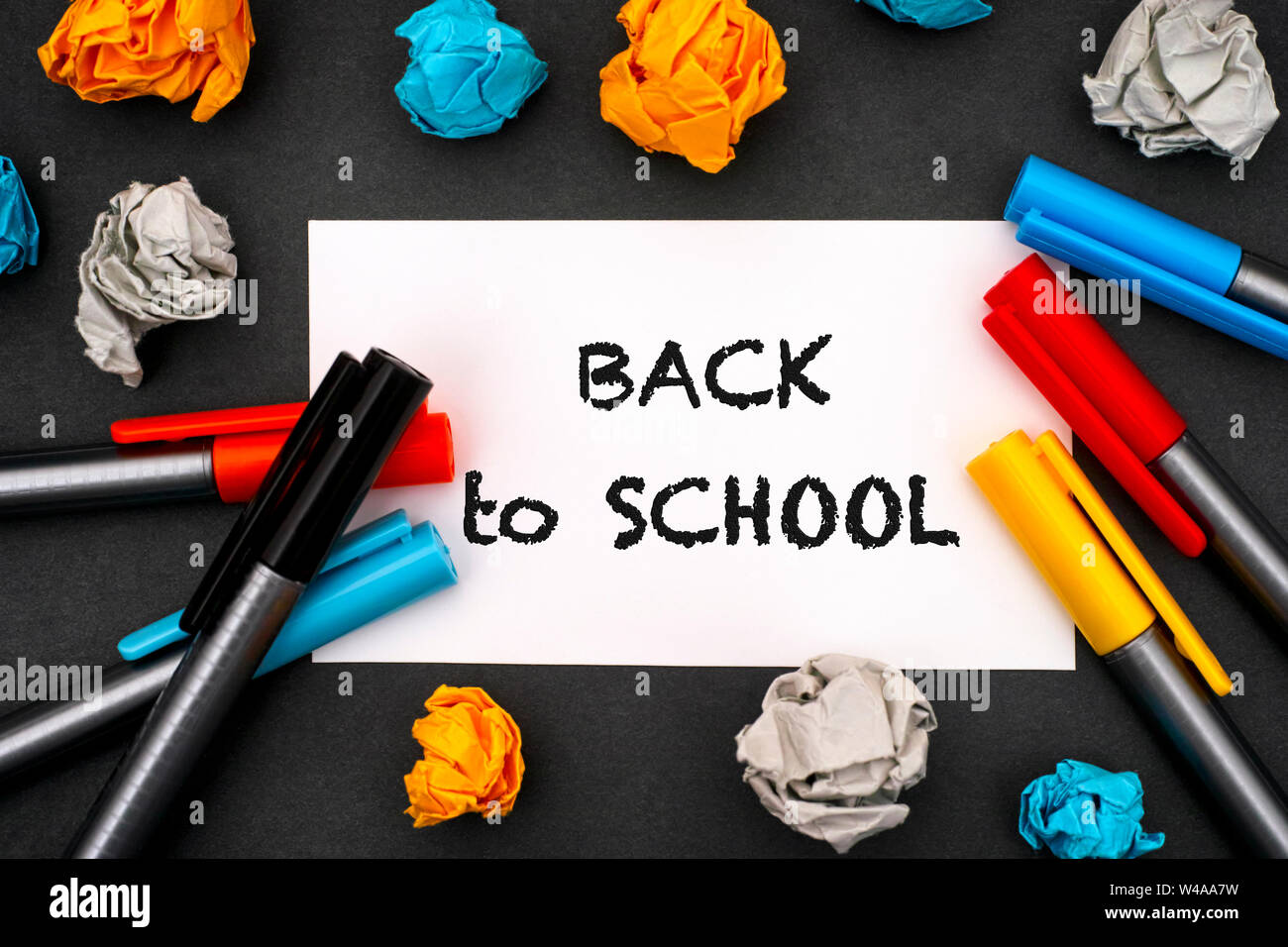 Phrase Back to School on white paper blank with colour pens and ...
