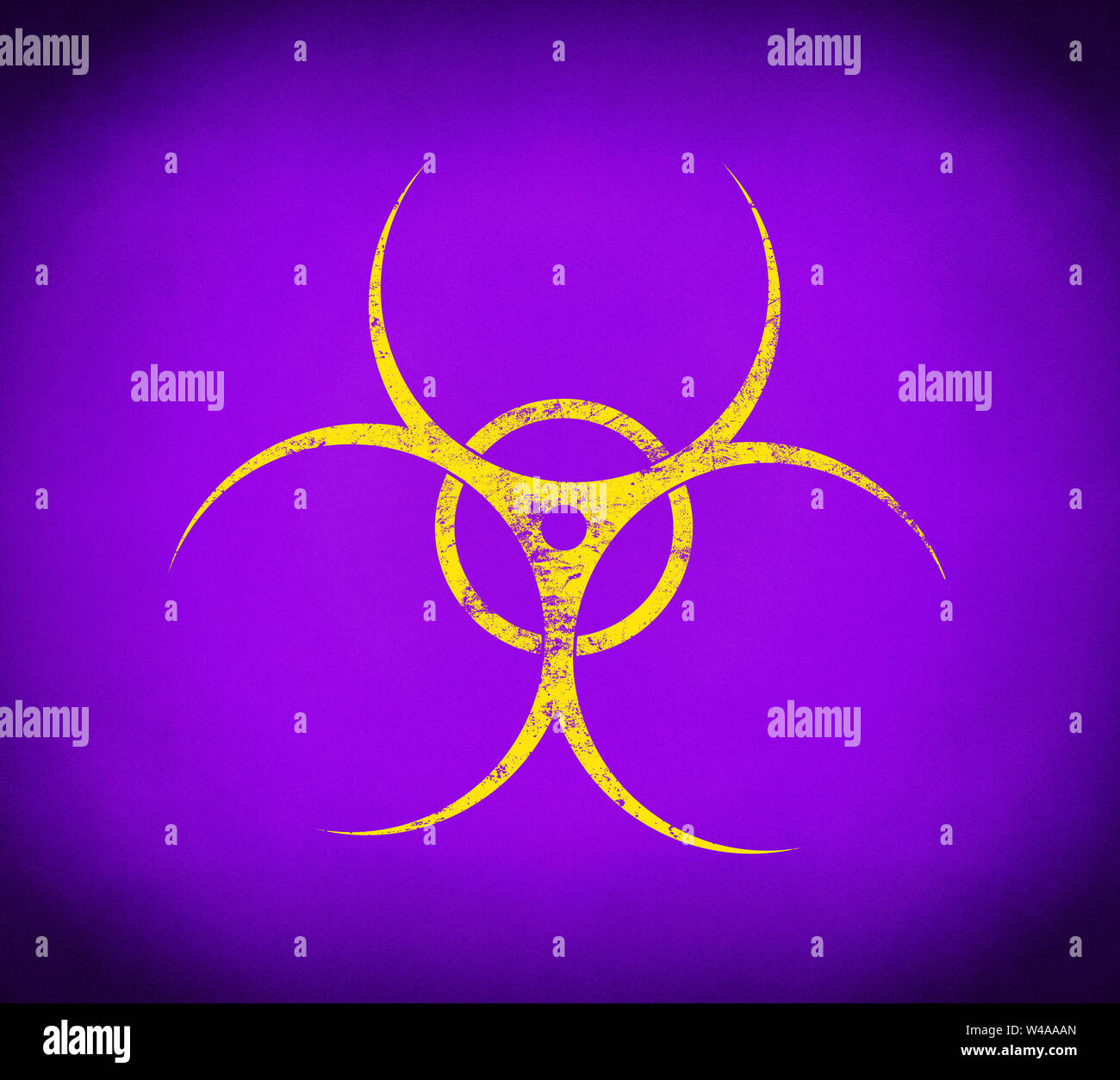 Yellow biohazard warning sign painted over grunge purple violet ...