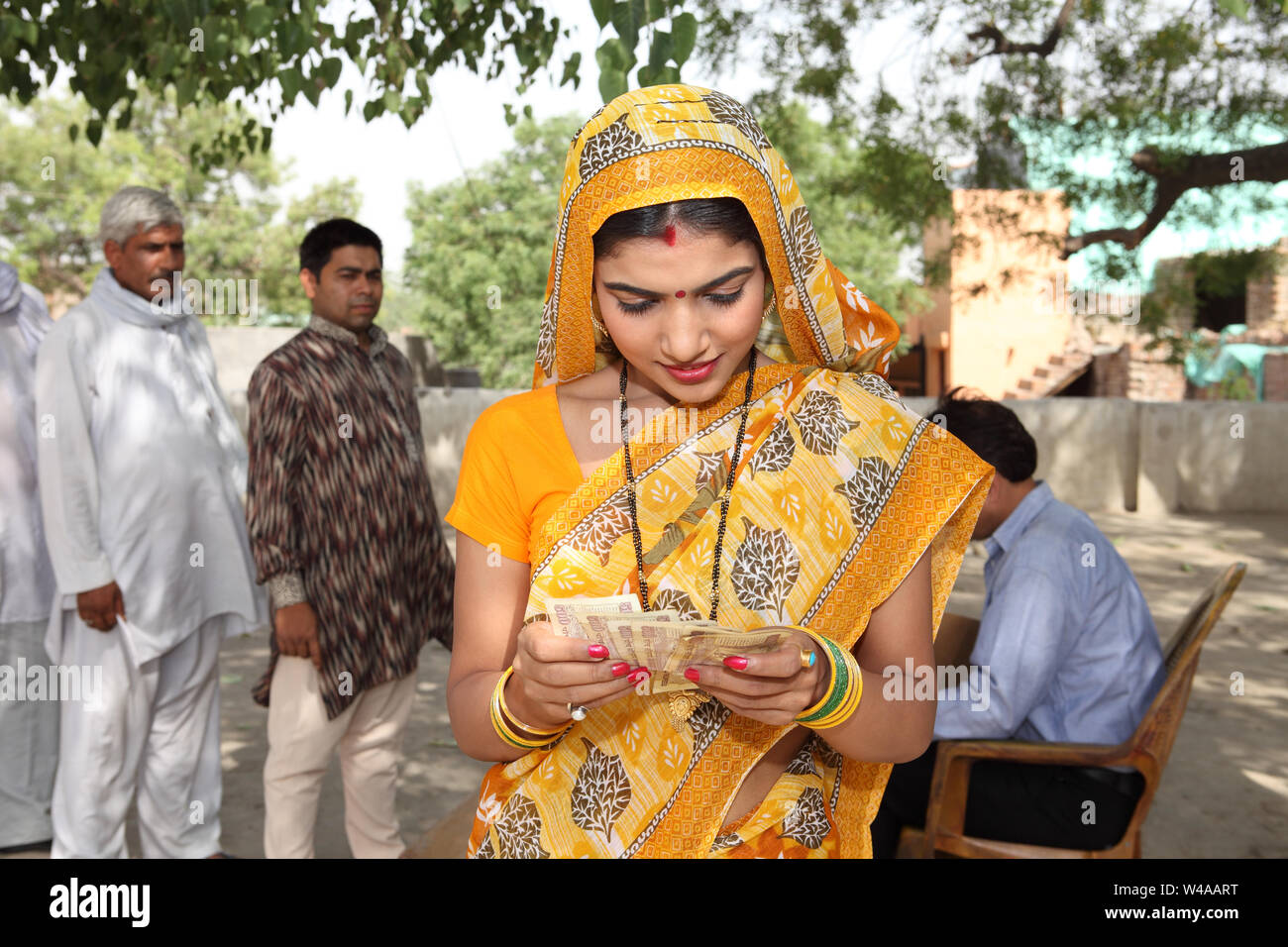 Rural woman counting money Stock Photo - Alamy
