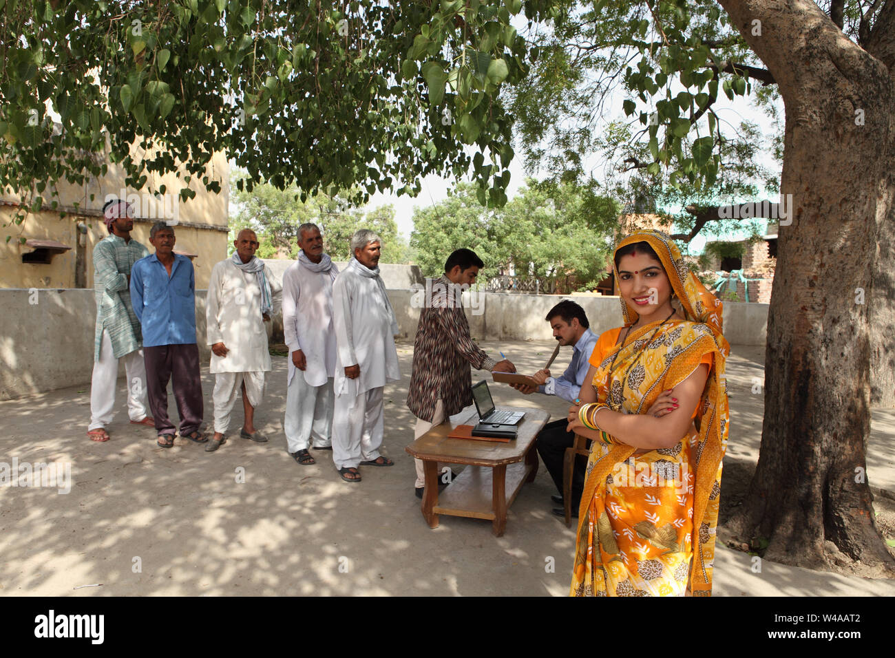 Bank executive distributing money to rural people Stock Photo - Alamy
