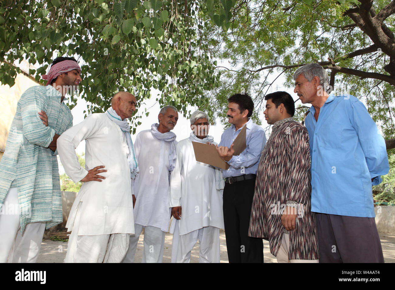Executive explaining a rural people on file Stock Photo - Alamy