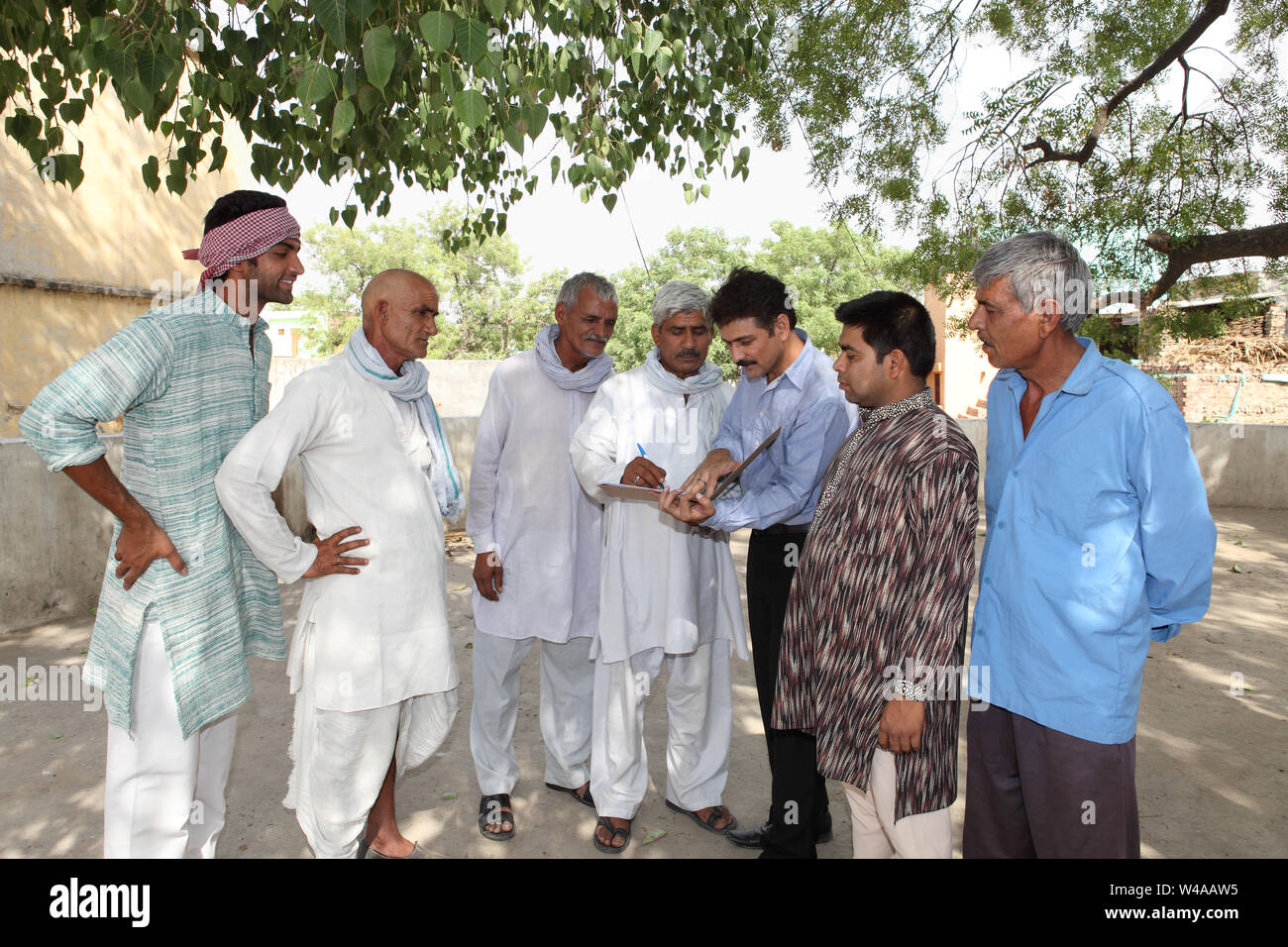 Executive explaining a rural people on file Stock Photo - Alamy