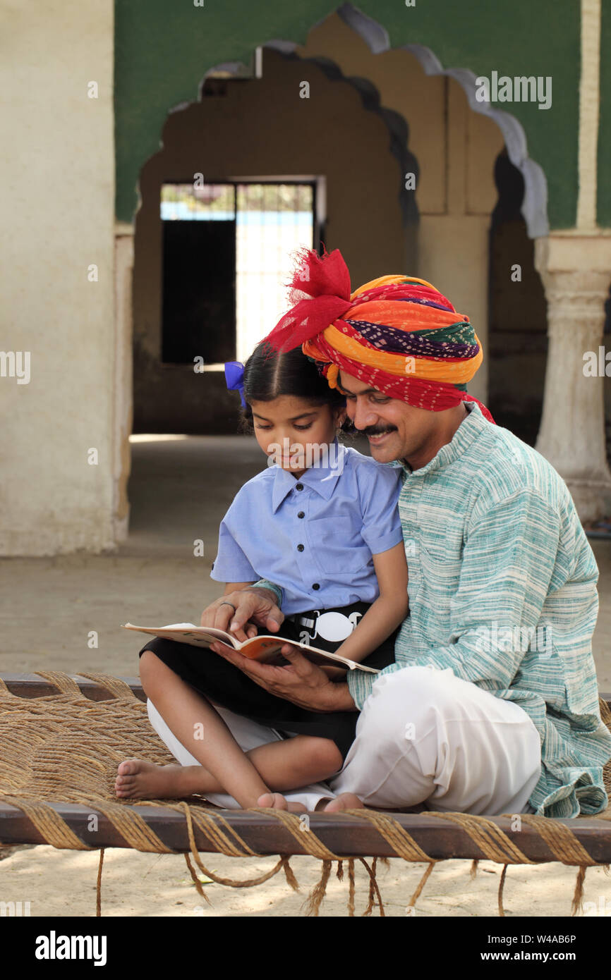Indian man teaching his daughter Stock Photo - Alamy
