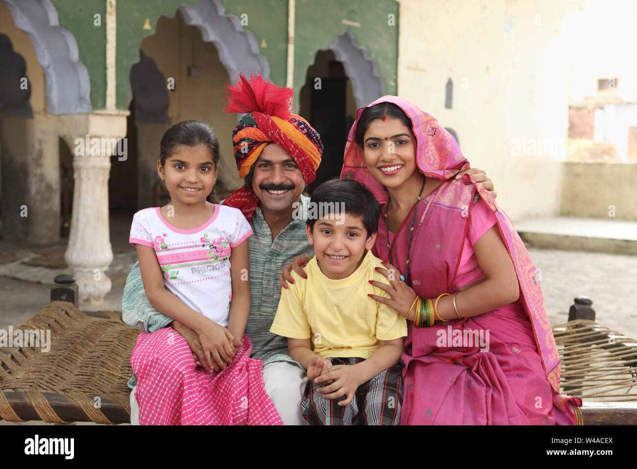 Portrait of a rural family sitting together and smiling Stock Photo - Alamy