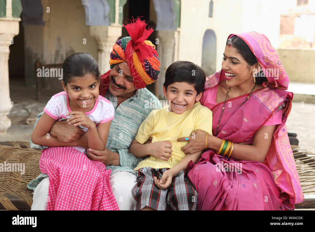 Portrait of a rural family sitting together and smiling Stock Photo - Alamy