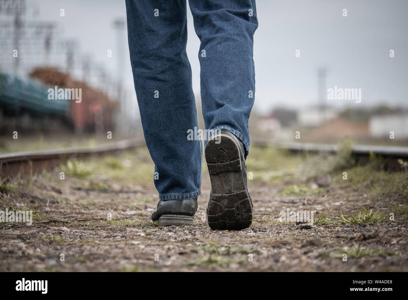 Man Walking Along Train Tracks Stock Photo - Alamy
