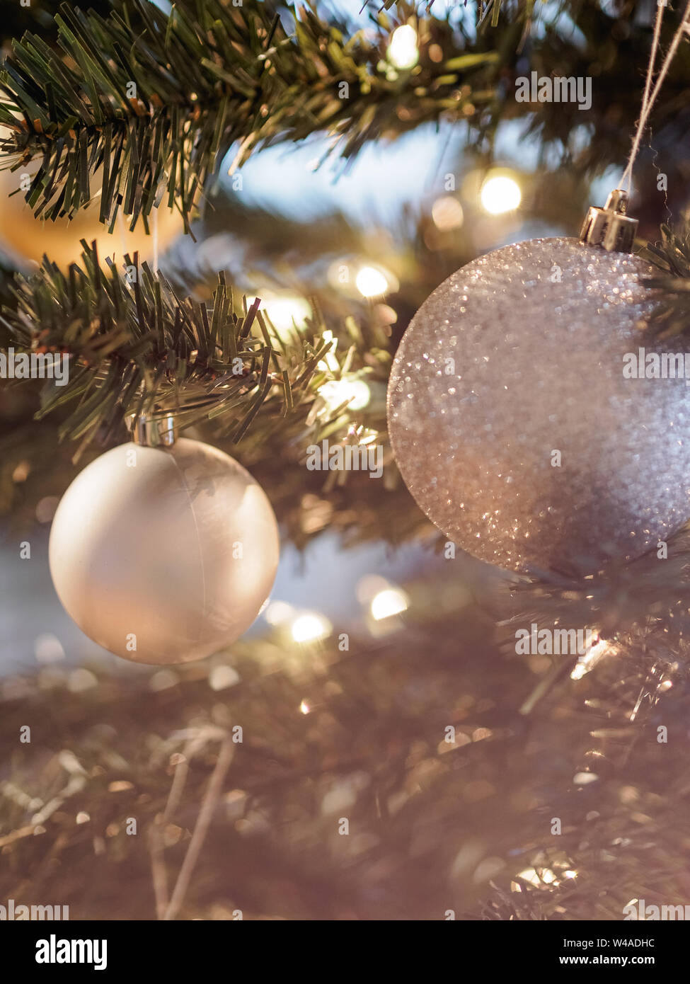 Golden glow of Christmas lights in defocussed with pastel colors ...