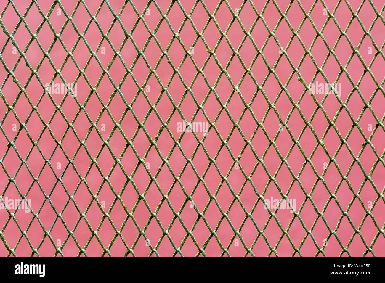 Image of metal grid on pink wall background for use as abstract ...