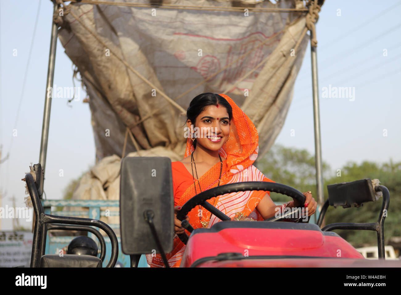 Indian woman driving a tractor Stock Photo - Alamy