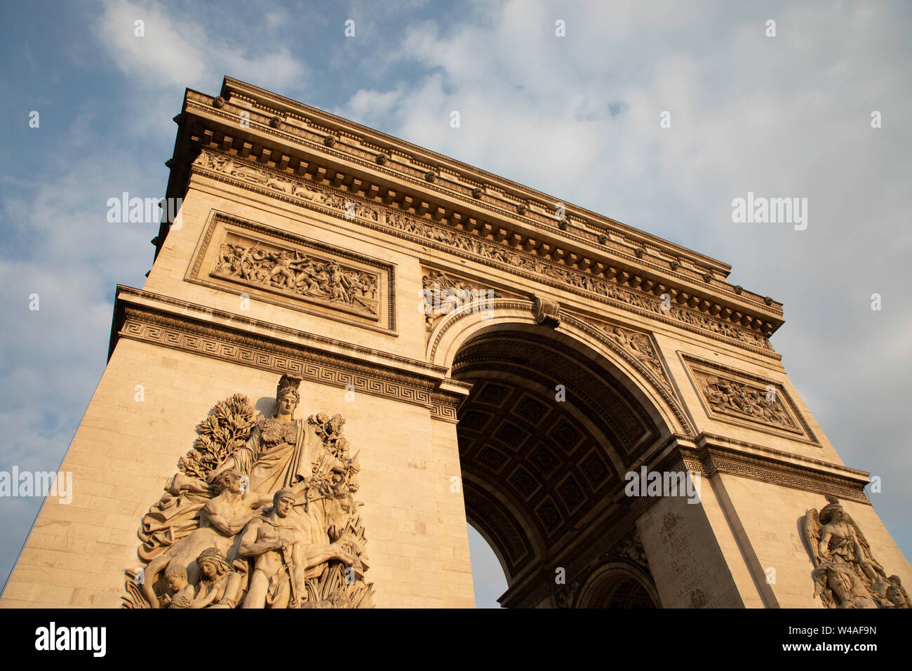 A view of the top of the Arc De Triomphe from ground perspective in ...