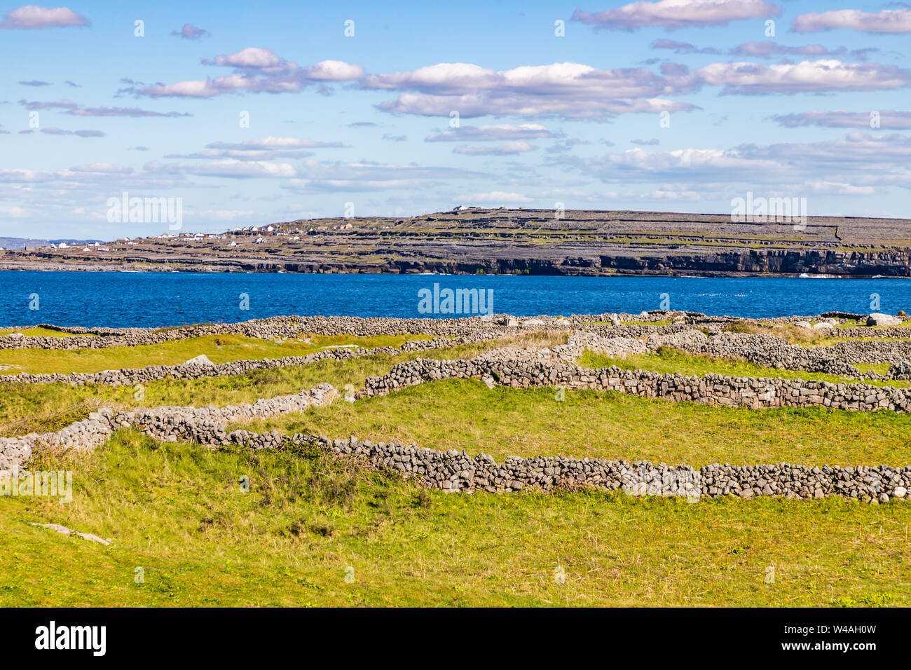Farm fields and ocean with Inishmaan island in background in Inishmore ...